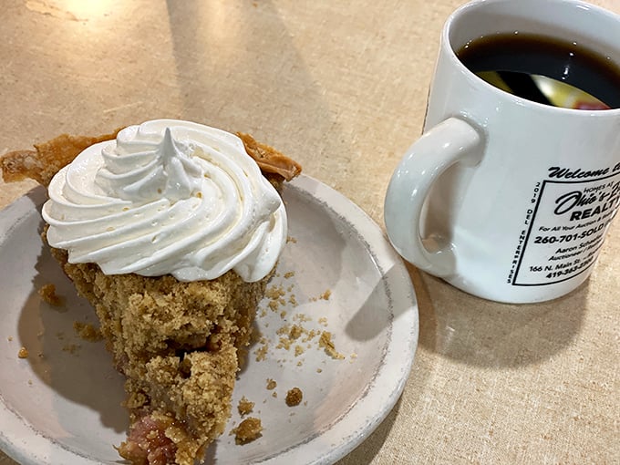 A slice of pumpkin pie with a mountain of whipped cream – proof that sometimes the best things in life require two hands and zero shame.