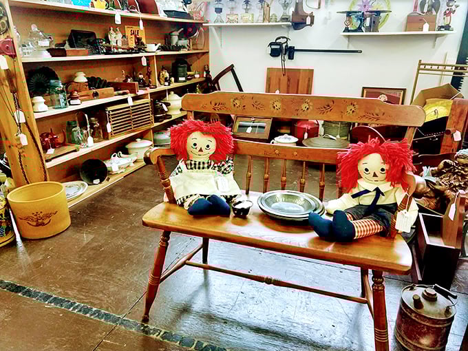These vintage Raggedy Ann dolls aren't just toys—they're childhood memories sitting patiently on an antique bench, waiting for someone to remember them.