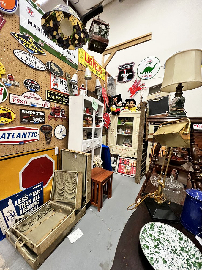 Vintage advertising signs create a museum of American marketing. Sinclair, Esso, Atlantic—these brands built our highways and now decorate our walls.