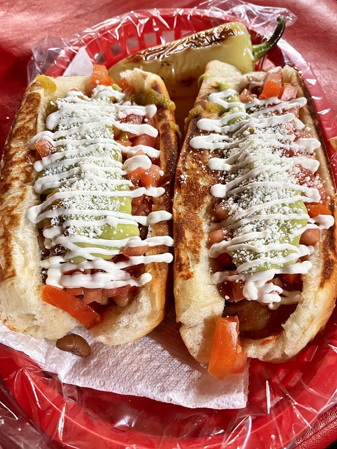 Hot dog architecture that deserves its own HGTV special. Those zigzag mayo lines are the culinary equivalent of curb appeal.
