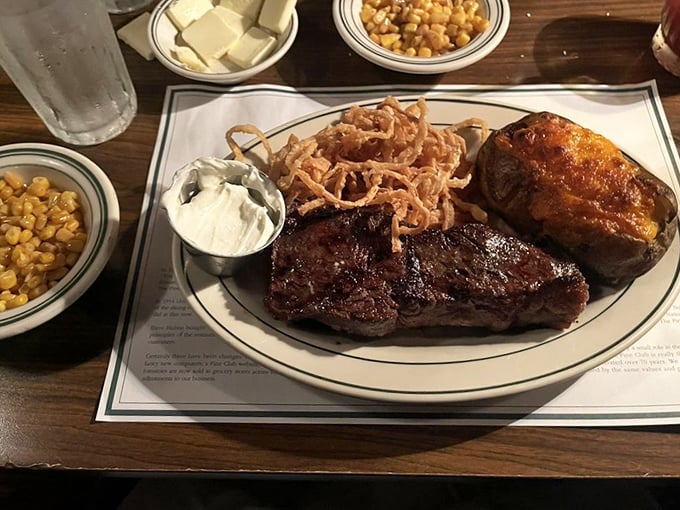 This isn't just a steak; it's a masterclass in simplicity—perfectly seared beef alongside those famous onion rings and stewed tomatoes.