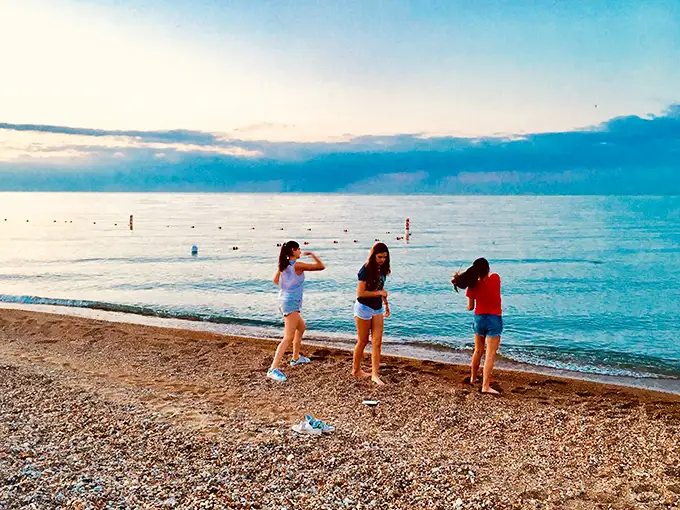 Twilight transforms the shoreline into nature's theater. These beachgoers know the secret—Glencoe's evening light show rivals anything on Broadway, and the tickets are free.