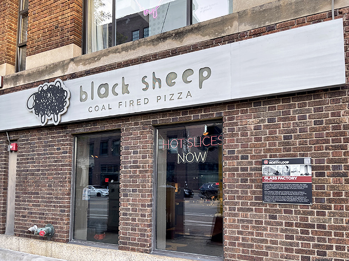 Black Sheep Coal Fired Pizza: That bold "HOT SLICES NOW" sign speaks the universal language of pizza urgency—when you need it, you need it now.