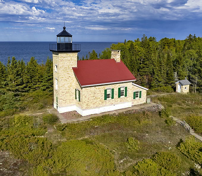 Copper Harbor's lighthouse stands sentinel over Lake Superior, a stone guardian that's witnessed a century of wild weather and wilder stories.