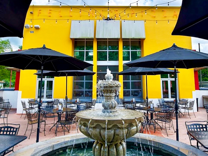 Sunshine yellow walls and a bubbling fountain – Felini's outdoor oasis makes pizza feel like a mini vacation in the heart of Atlanta.