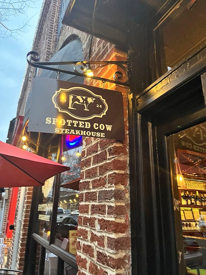The Spotted Cow's vintage sign promises what lies within—a carnivore's playground in historic brick surroundings.
