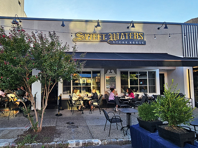 Sweet Waters' inviting patio scene – where summer evenings, good company, and exceptional steaks create perfect memories.