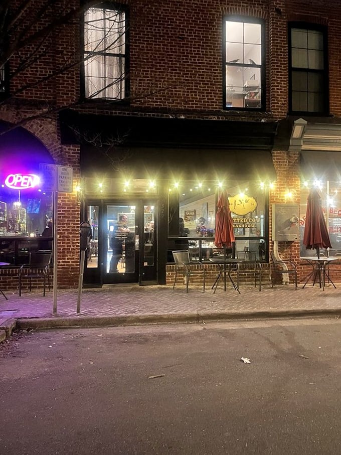 Evening lights transform this brick facade into a beacon for beef lovers seeking refuge from chain restaurant mediocrity.