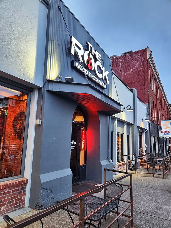 The Rock's entrance glows with promise at dusk, drawing pizza pilgrims like moths to a flame—a delicious, wood-fired flame.
