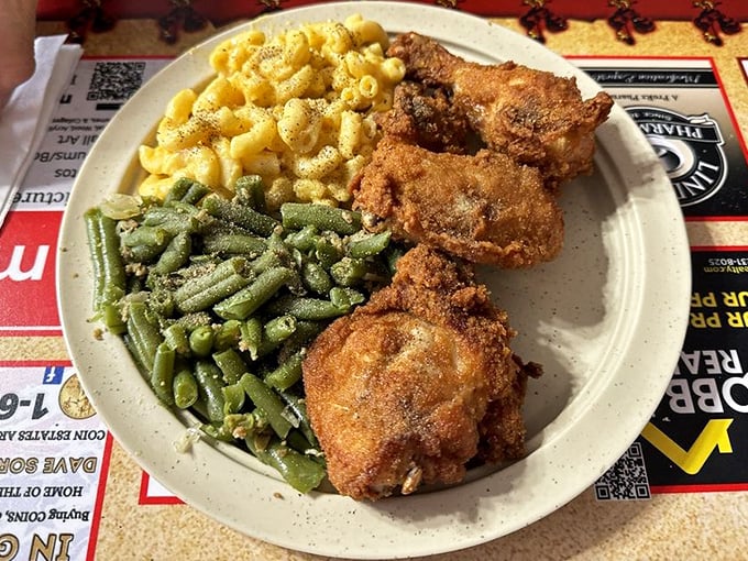 Three pieces of crispy-coated chicken with green beans and mac and cheese – proof that sometimes the simple things are life's greatest treasures.