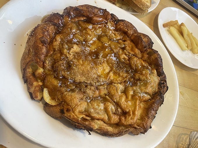 Not just an apple pancake – it's an architectural marvel of caramelized fruit and puffy batter that makes ordinary breakfast seem like a missed opportunity.