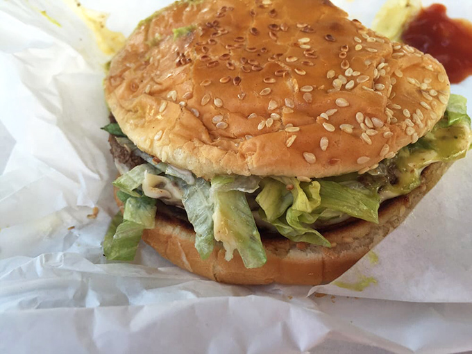 Behold the avocado burger in its natural habitat—nestled in wax paper, ready to transform your lunch from mundane to magnificent.