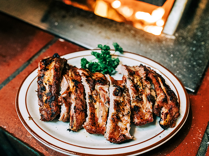 These baby back ribs aren't just falling off the bone—they're practically jumping into your mouth with smoky, charred perfection.