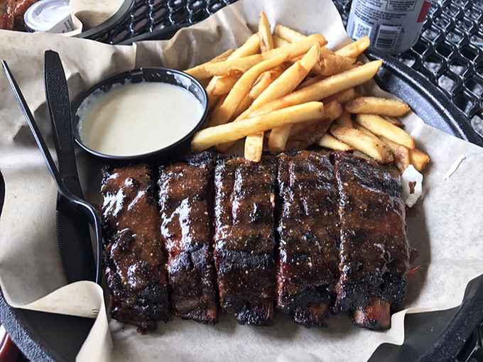 Ribs with that perfect bark and a side of golden fries. This isn't just food—it's edible architecture with a foundation of smoke, time, and patience.