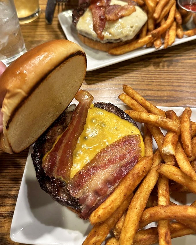The bacon cheeseburger at Joy Burgers doesn't just speak to you—it serenades your taste buds with a three-part harmony of beef, cheese, and perfectly crisped bacon.