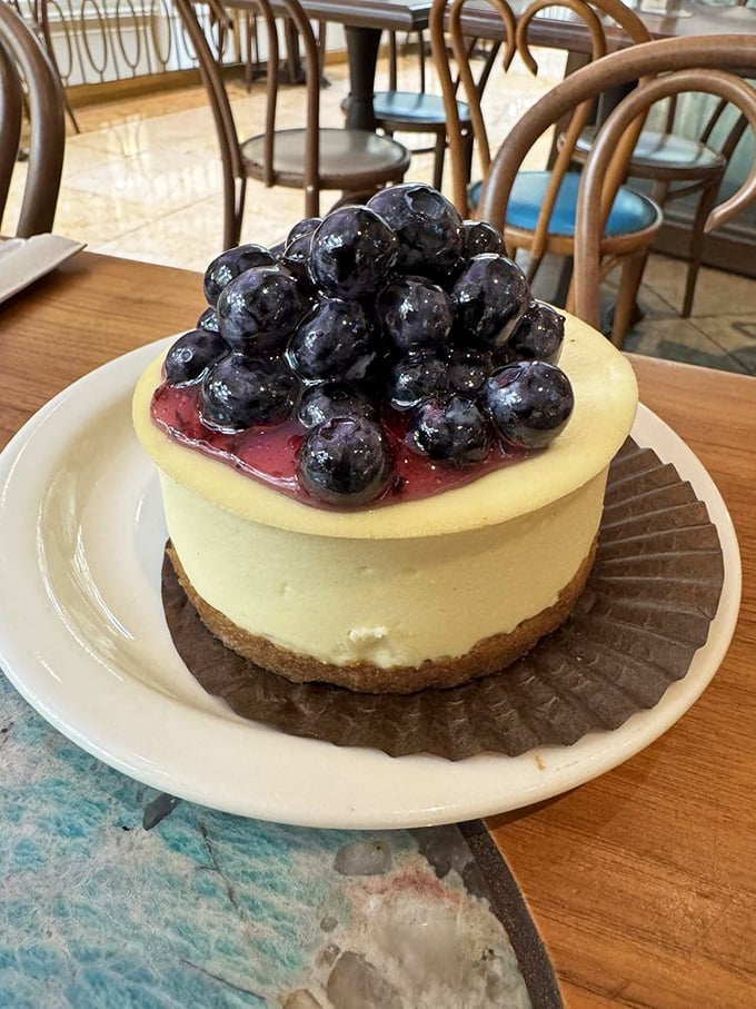 Blueberries piled high like tiny jewels atop creamy cheesecake – nature's perfect accessory for an already stunning dessert.