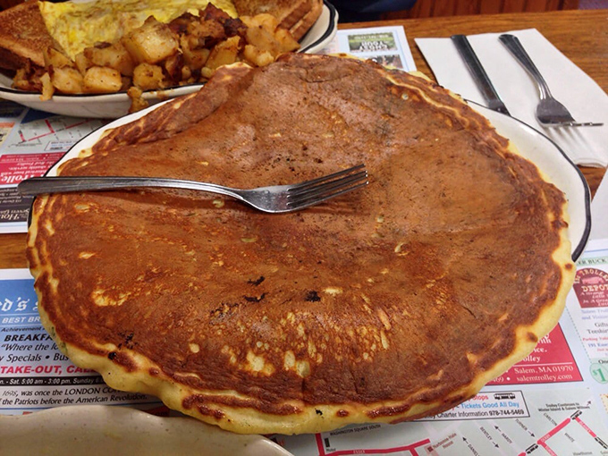 The pancake that launched a thousand road trips – golden-brown, plate-sized, and ready to make your ordinary morning extraordinary.