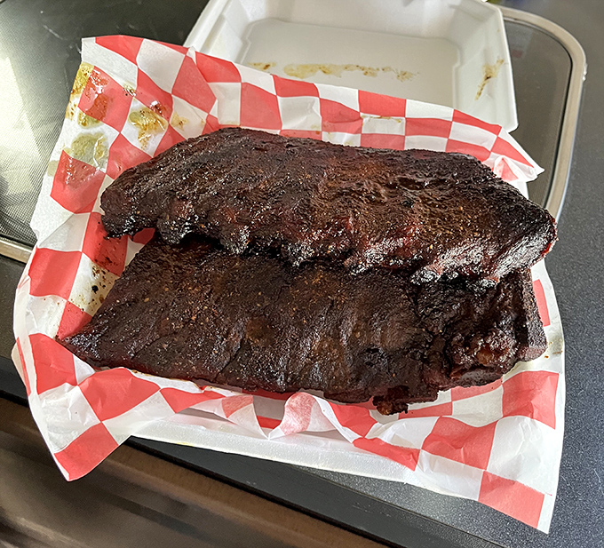 Behold the brisket—glistening with a mahogany bark that whispers sweet nothings about hours spent in the smoker's embrace.