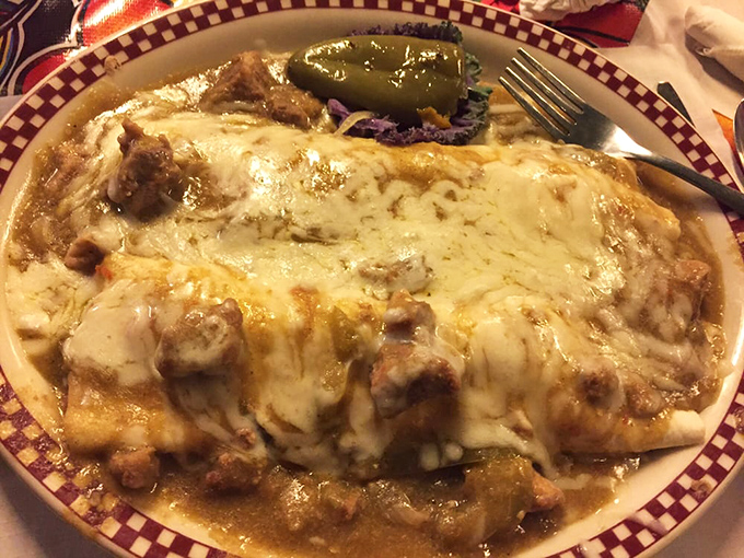 This burrito isn't just food; it's architecture—a masterpiece of construction where cheese cascades over perfectly seasoned meat like a dairy waterfall.