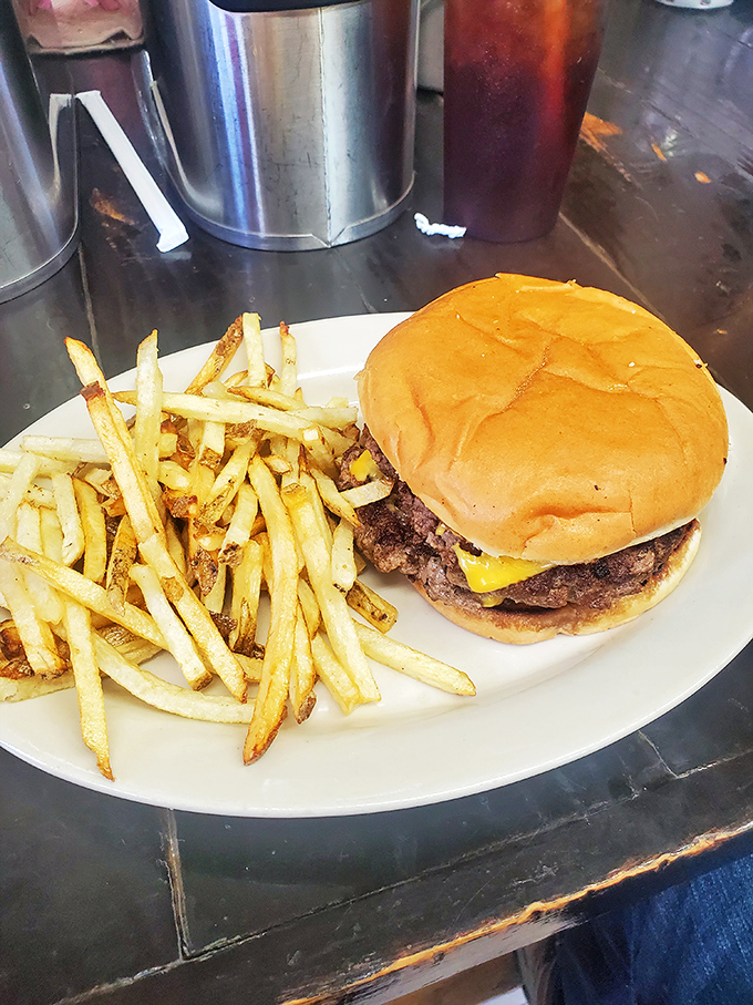 The classic cheeseburger and fries combo—proof that simplicity, when executed perfectly, can be the highest form of culinary art.