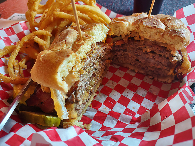 The mark of a proper diner burger: you need to strategize your approach before that first magnificent bite. Those onion rings aren't playing supporting roles—they're co-stars.