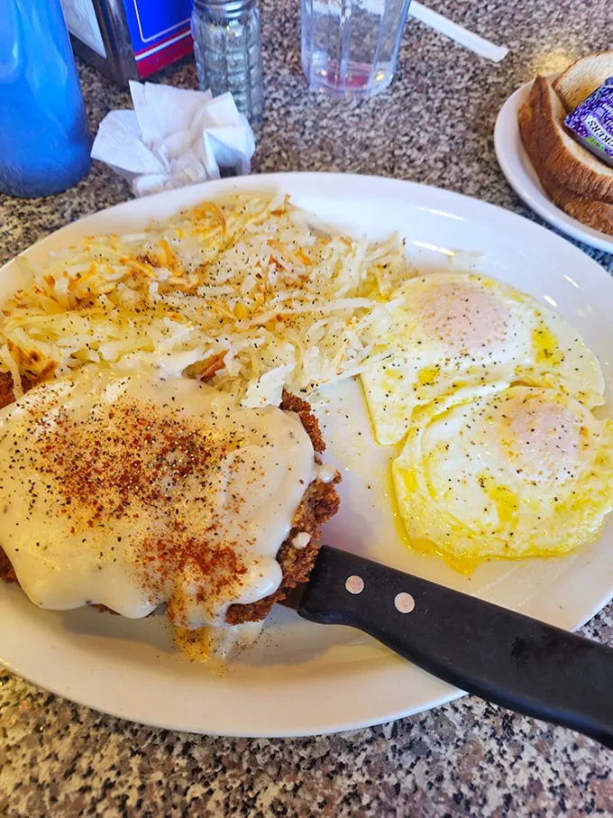 The star of the show in all its glory—chicken fried steak with a perfectly crisp exterior giving way to tender meat, all blanketed in gravy that could make a vegetarian reconsider.