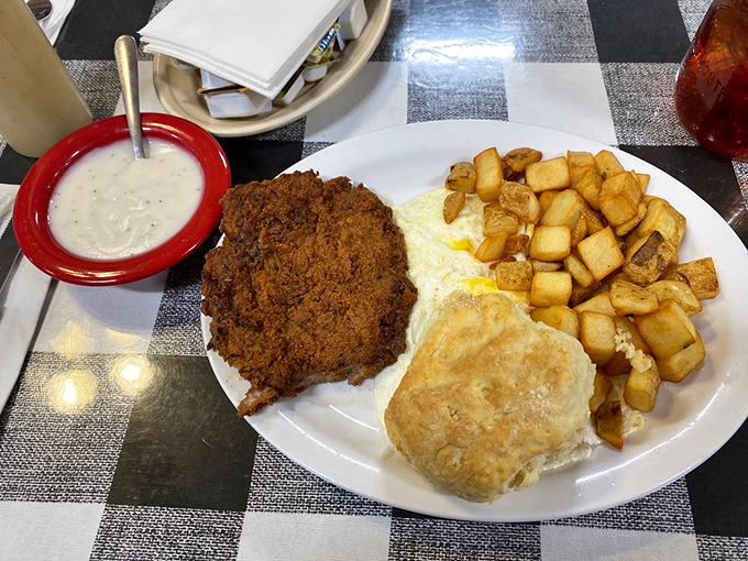 Chicken fried steak with a crust so perfect it deserves its own trophy, alongside potatoes that have been cubed with mathematical precision.