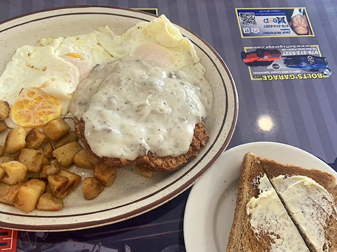 This isn't just Chicken Fried Steak—it's therapy on a plate. The golden-brown masterpiece under river of gravy alongside perfectly cooked eggs and home fries demands a moment of silence.