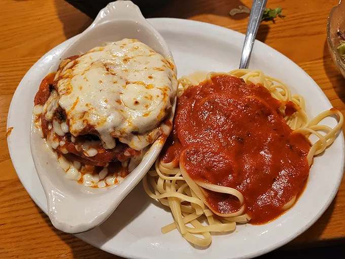 Chicken parm that doesn't know the meaning of portion control, served with a side of perfectly twirled spaghetti. This isn't a meal; it's a commitment.