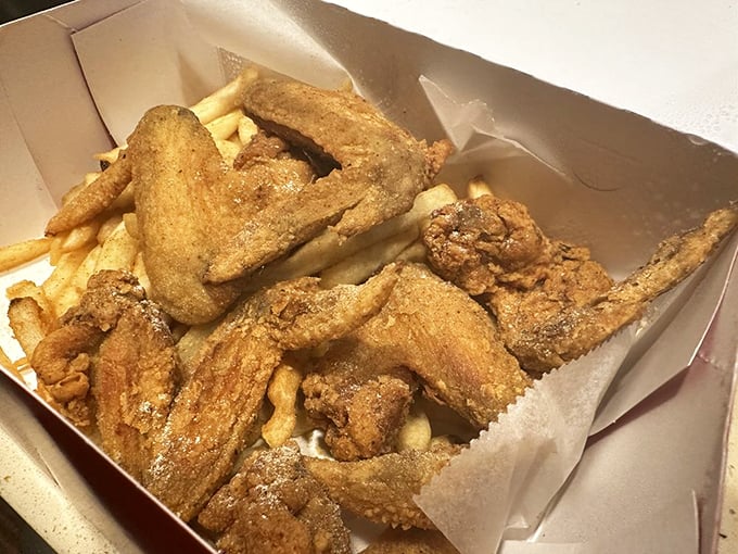 Wings and fries nestled together in their paper home—a marriage of crispy delights that's lasted longer than most Hollywood relationships.