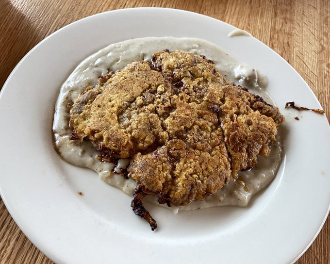 This chicken fried steak isn't just dinner—it's edible therapy, with a crispy coating that shatters like childhood memories.