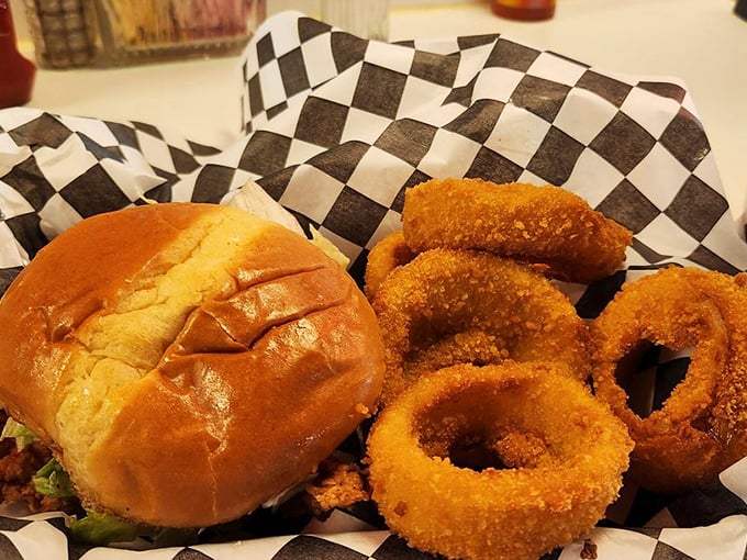 The yin and yang of diner perfection: a golden-brown chicken sandwich paired with crispy onion rings that shatter with each satisfying bite.