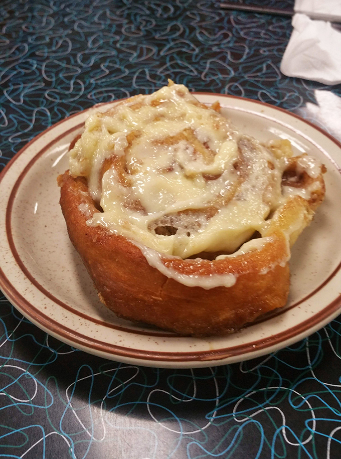 This isn't just a cinnamon roll—it's a gooey, buttery spiral of happiness that makes calorie-counting seem like the saddest hobby in the world.