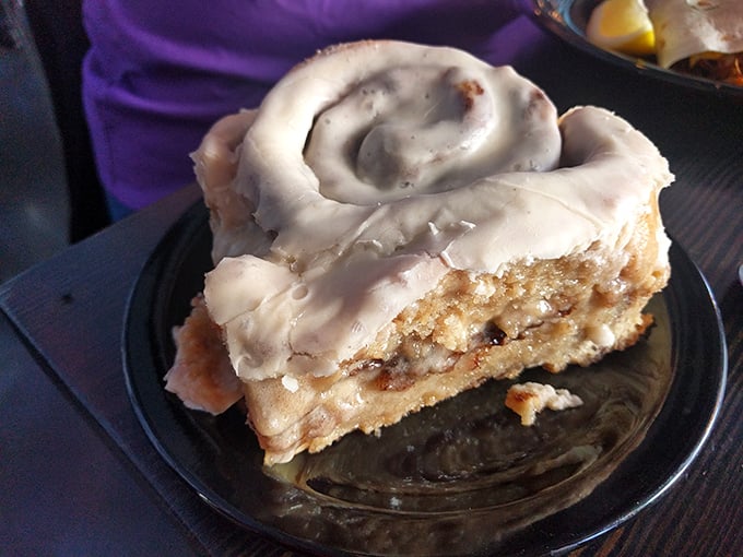 The cinnamon roll isn't just a side—it's the main event, with swirls of cinnamon and cream cheese icing that would make any pastry chef proud.