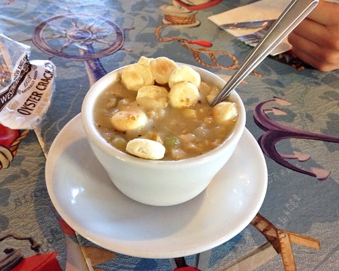 Clam chowder so hearty the spoon practically stands at attention, crowned with oyster crackers like little life rafts on a creamy sea.