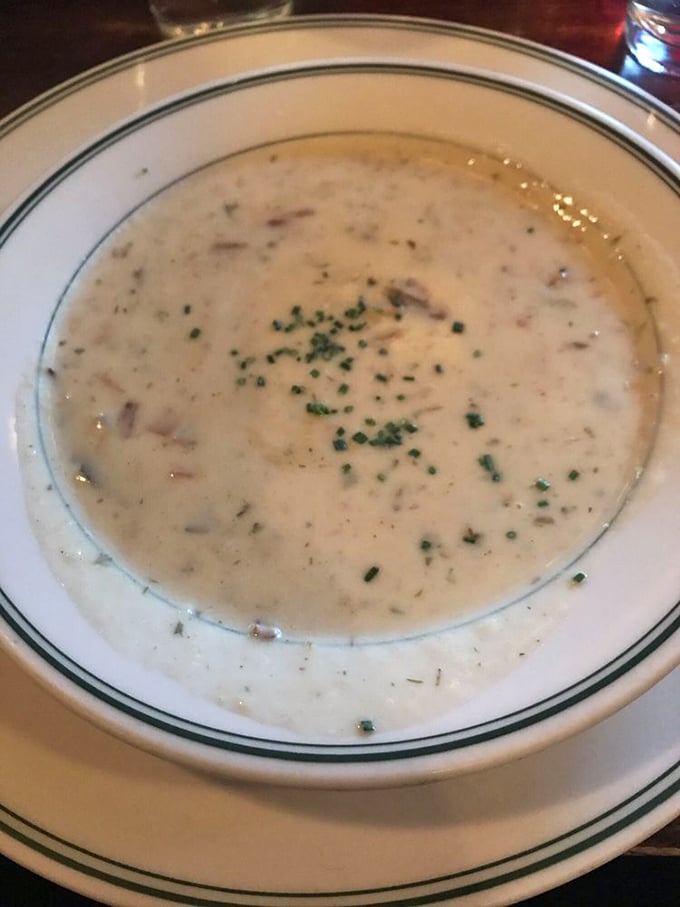 A bowl of clam chowder so creamy it should come with a warning label. Those little flecks of herbs aren't garnish – they're little green flags of victory.