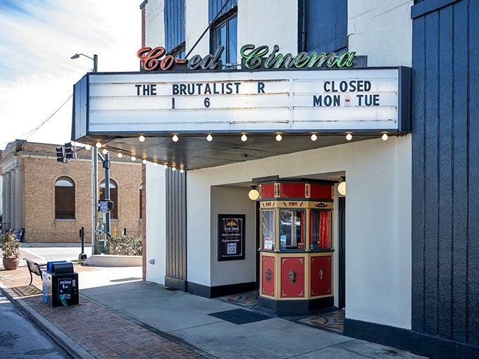 The Co-Ed Cinema marquee glows with vintage charm, offering movie magic the way it was meant to be experienced – without fourteen superhero previews.