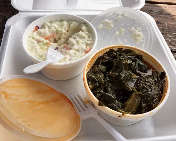 The supporting cast deserves applause too—creamy coleslaw and collard greens that have clearly been simmering with purpose and conviction.