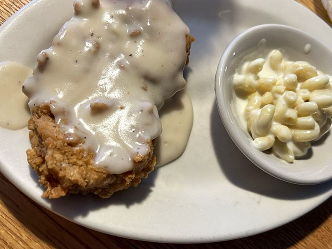 Country fried steak smothered in creamy gravy with a side of mac and cheese—comfort food that hugs your soul before it fills your stomach.