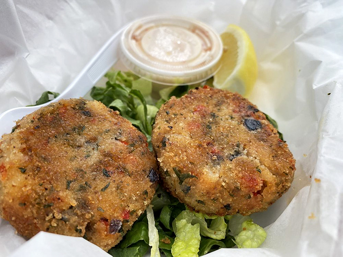 Golden-brown crab cakes that don't hide behind fillers—just pure, unadulterated crab with a crispy exterior that shatters with each bite.