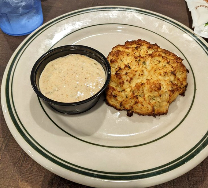 This golden-brown crab cake isn't trying to reinvent the wheel—it's just executing it flawlessly. The accompanying sauce adds a tangy counterpoint to the sweet crab.