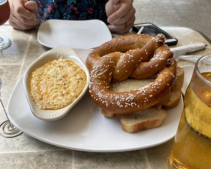That giant pretzel isn't compensating for anything—it knows exactly how good it is, especially when dunked in that creamy crab dip.