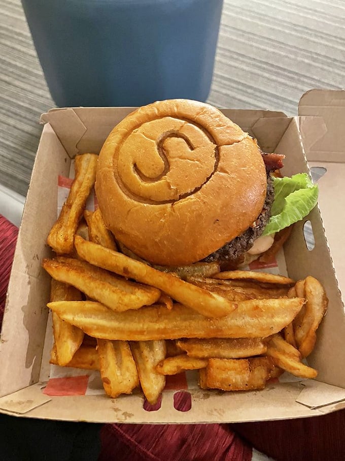 The S-shaped bun isn't just showing off – it's cradling that perfect patty and fresh toppings like they're precious cargo. Fries included, happiness guaranteed.