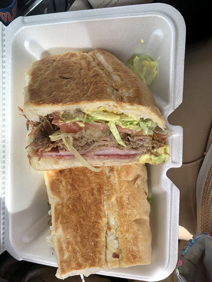 This Cuban sandwich isn't just pressed – it's been persuaded into perfection, layers of ham, pork, and cheese creating the kind of harmony that would make a barbershop quartet jealous.