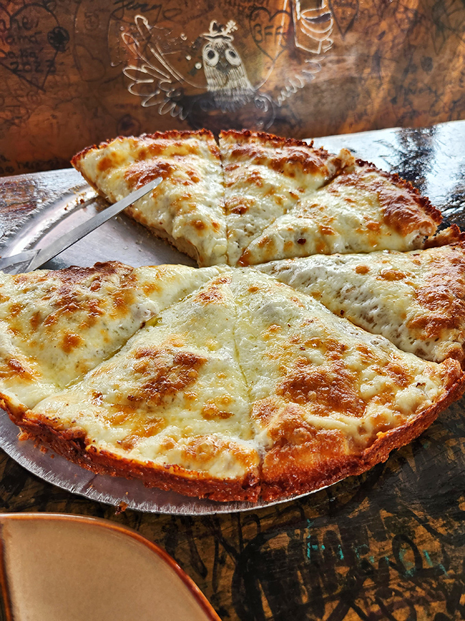 The white pizza doesn't whisper, it announces itself with authority – a perfect canvas of cheese with edges crisped to golden perfection.