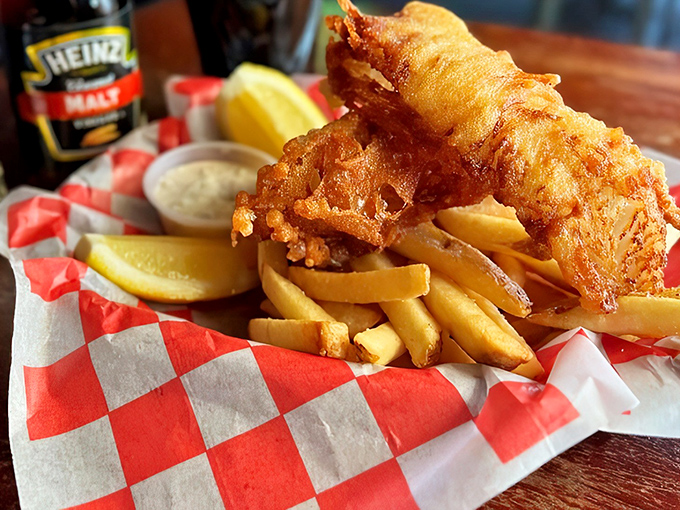 This isn't just fish and chips—it's edible architecture. The golden ratio of crispy exterior to flaky interior would make Leonardo da Vinci weep with joy.