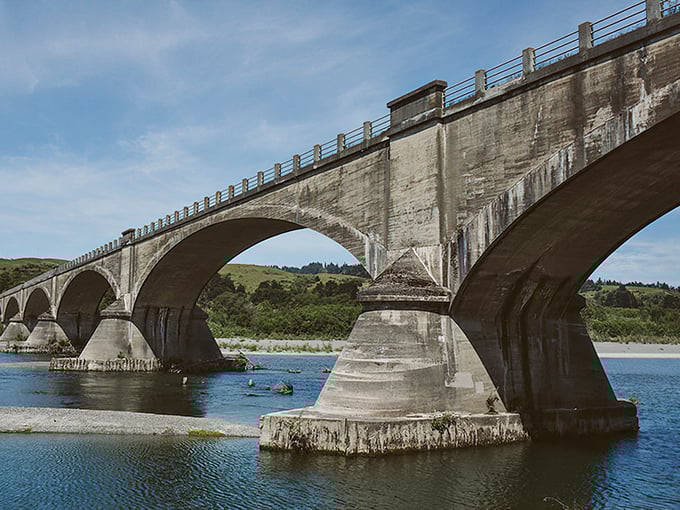 This historic concrete bridge spans more than water – it connects past and present with timeless engineering elegance. 