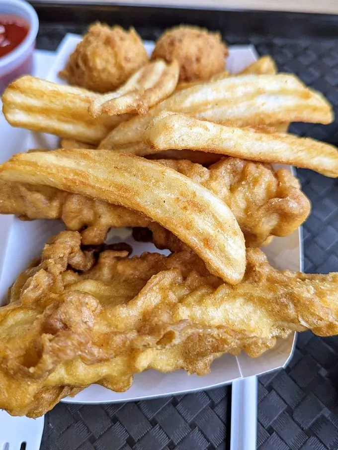 The fish and chips platter – where crispy batter meets flaky white fish in a marriage so perfect it deserves its own reality show.