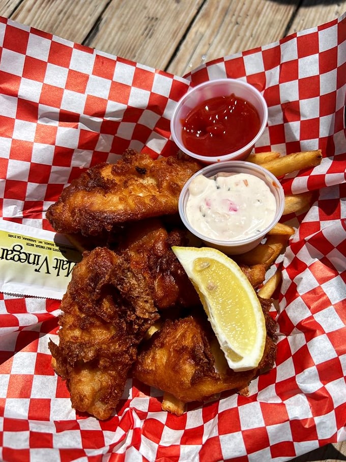 Golden-battered fish and hand-cut fries served in a red checkered basket—the kind of simple pleasure that makes you question why anyone would eat anything else.