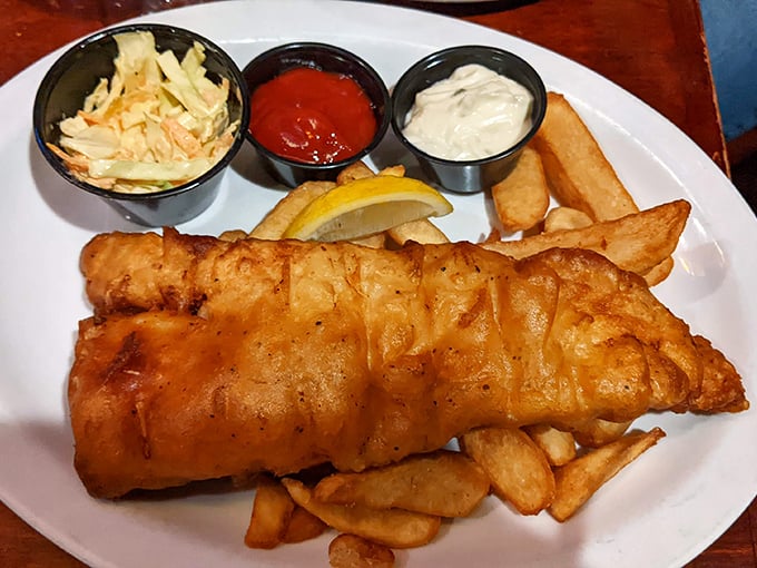 Fish and chips done proper – crispy exterior giving way to flaky white fish, with tangy coleslaw providing that perfect counterpoint. God save the cuisine!
